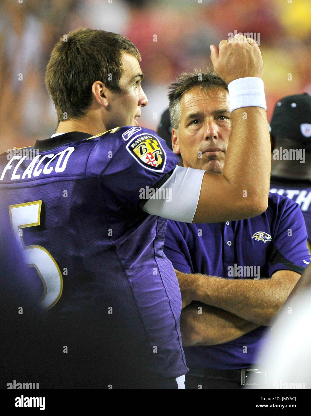 Baltimore Ravens quarterback Joe Flacco (5), left, discusses strategy ...