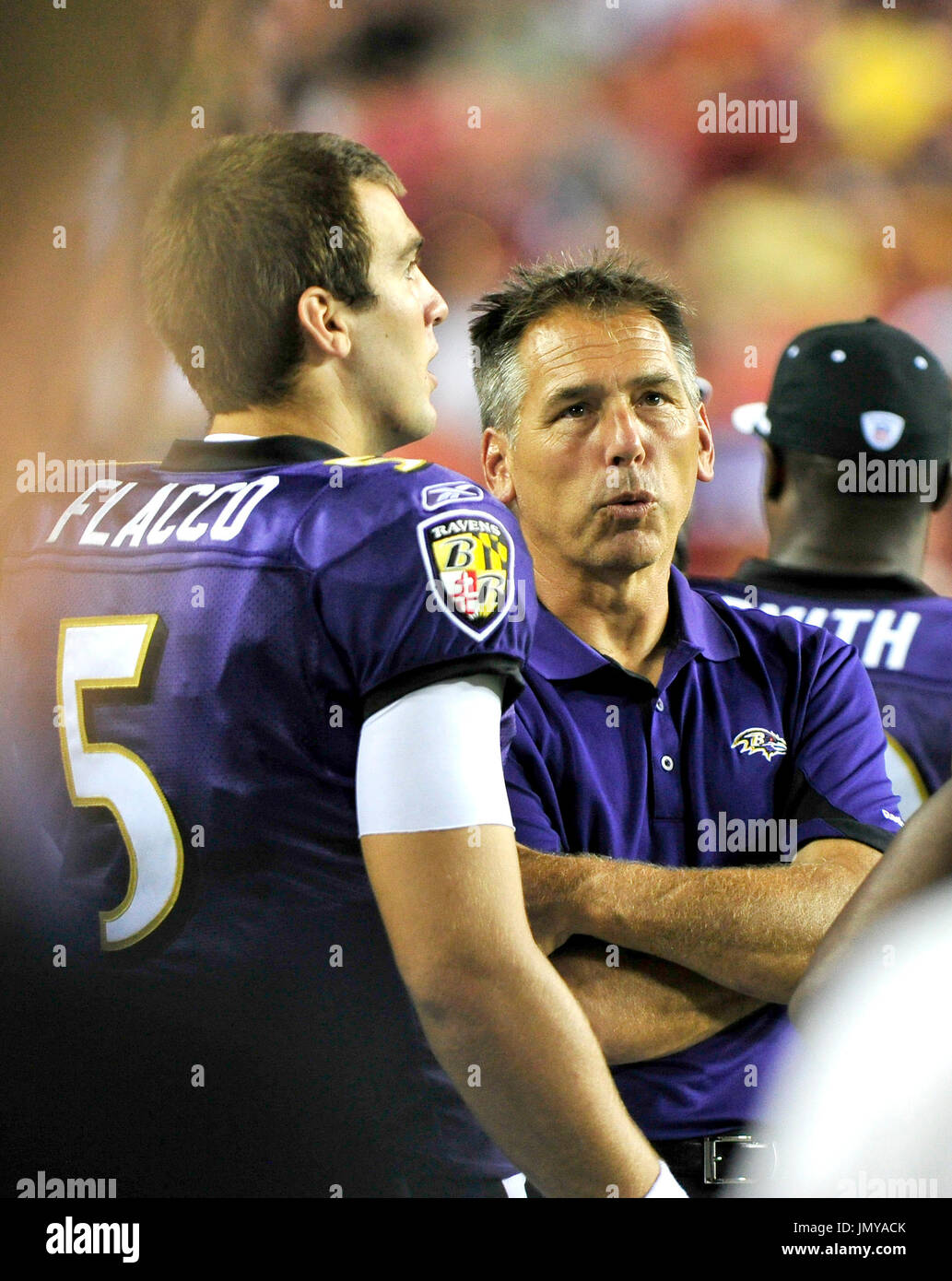 Baltimore Ravens quarterback Joe Flacco (5), left, discusses strategy ...