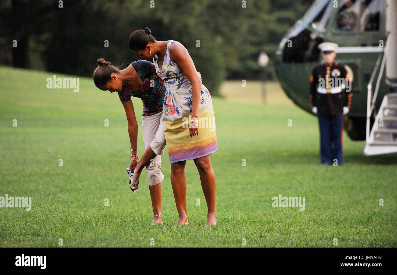 First Lady Michelle Obama waits for her daughter, Sasha, who had a ...