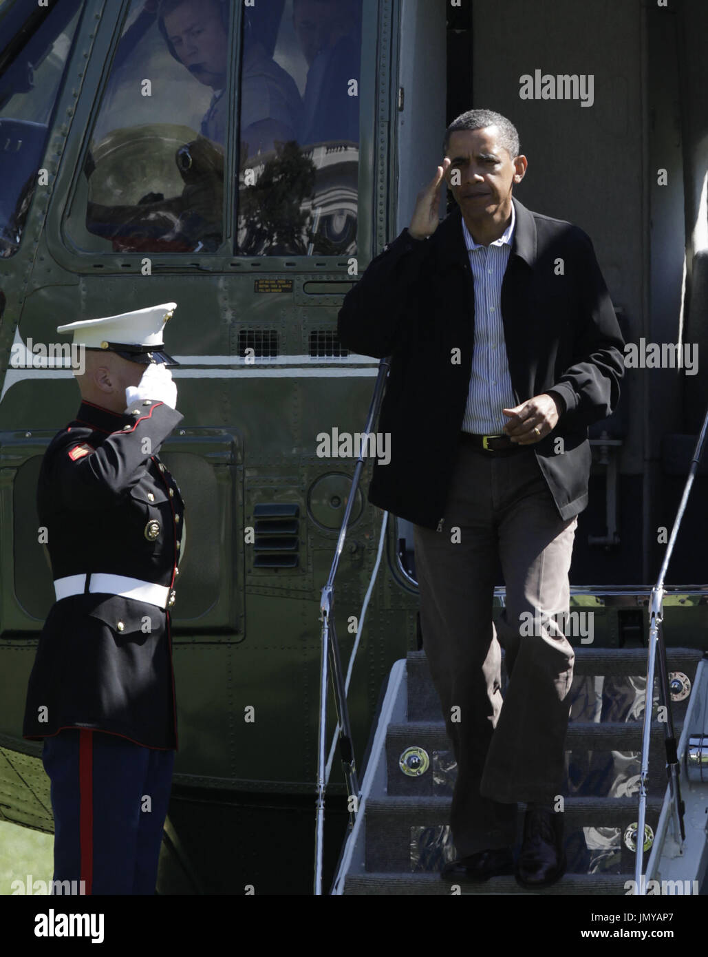 United States President Barack Obama salutes from the steps of the ...