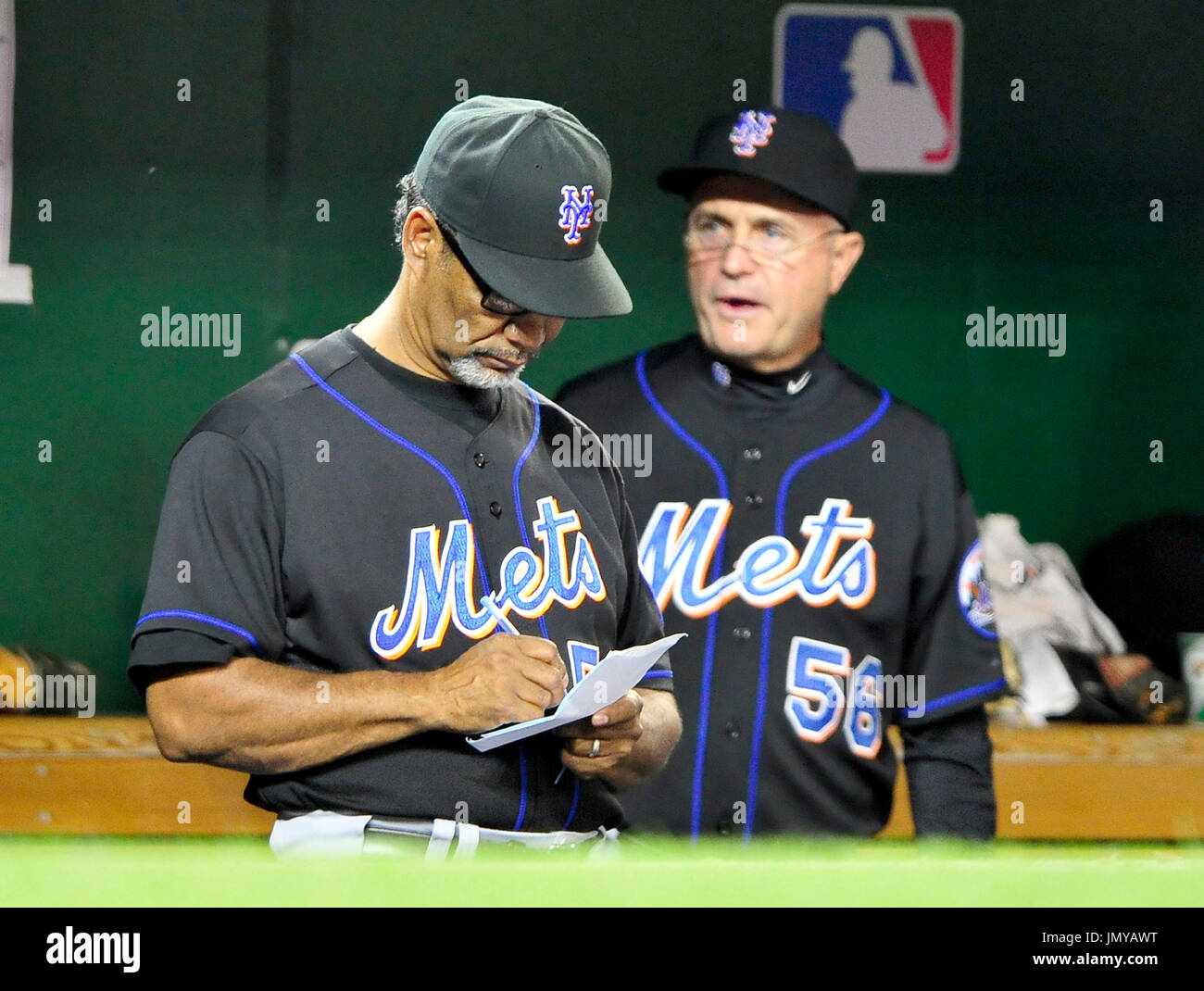 New York Mets manager Jerry Manuel (53) looks over his notes as coach ...