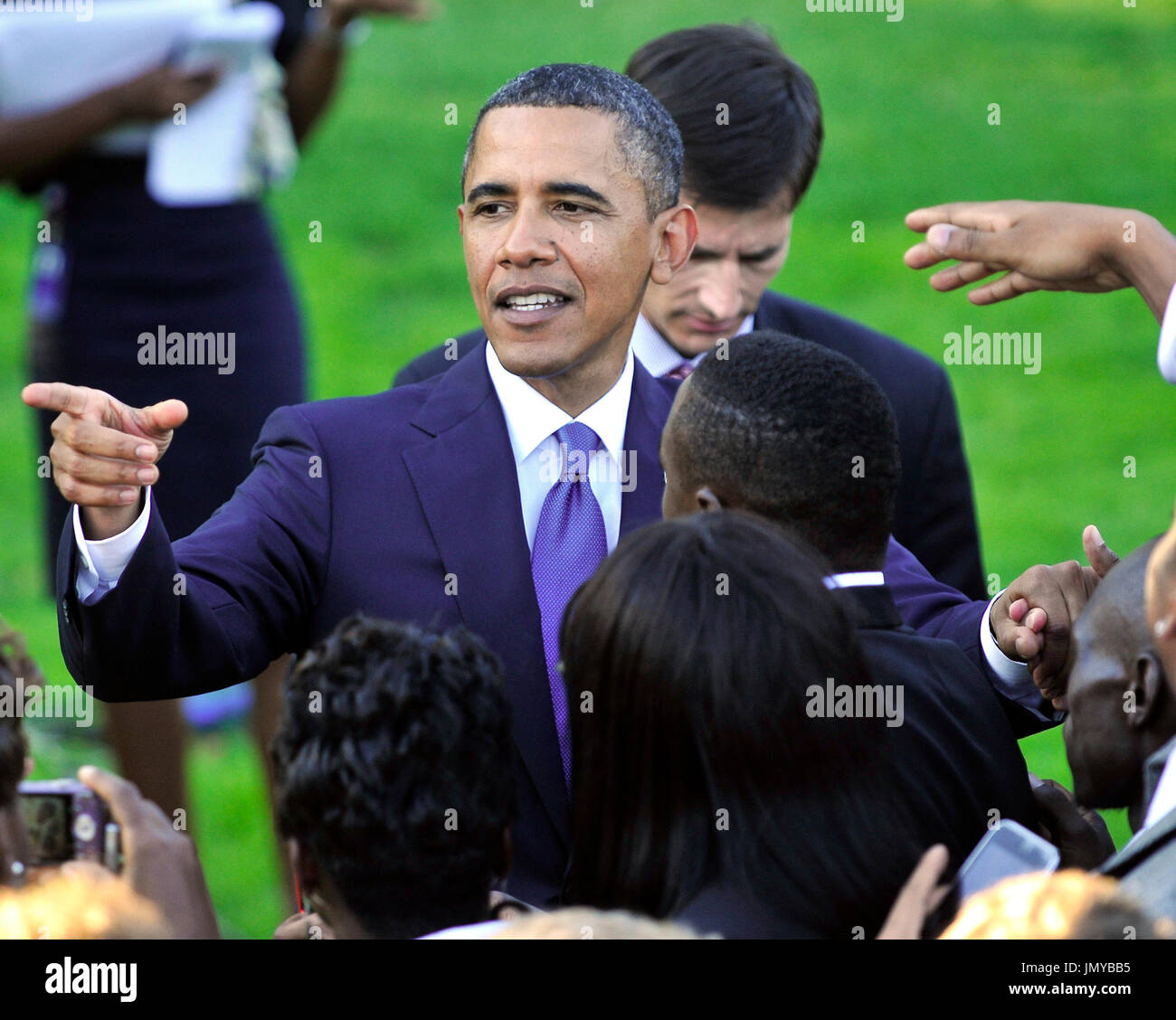United States President Barack Obama points as he shakes hands after ...