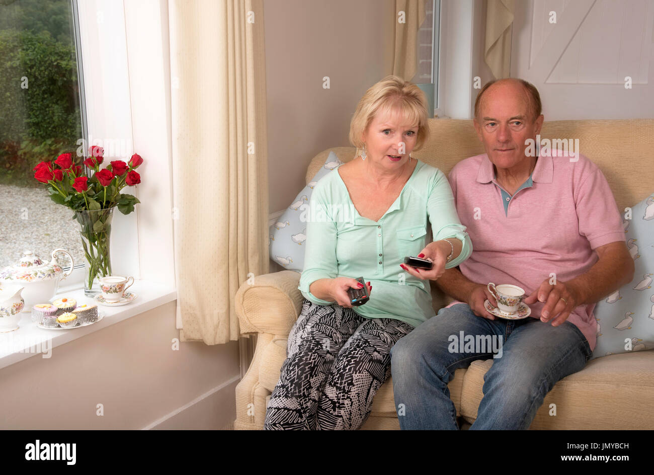 Tv program remote control couple hi-res stock photography and images ...