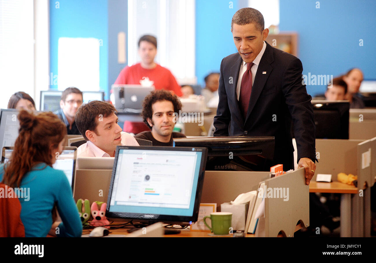 United States President Barack Obama gets some information from ...