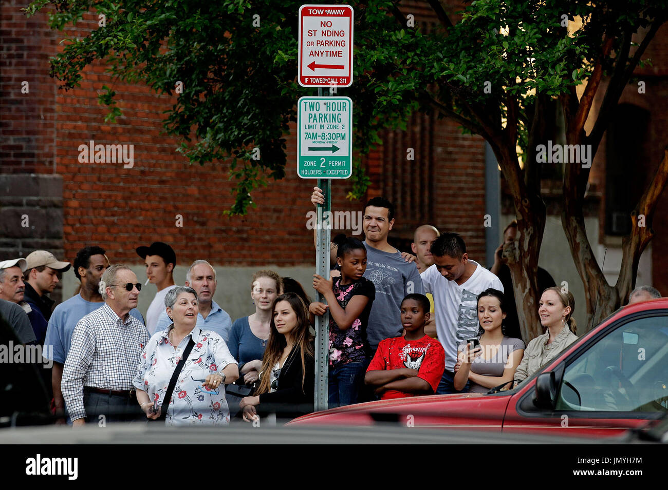 A crowd gathers across the street from the Komi restaurant in hopes of ...