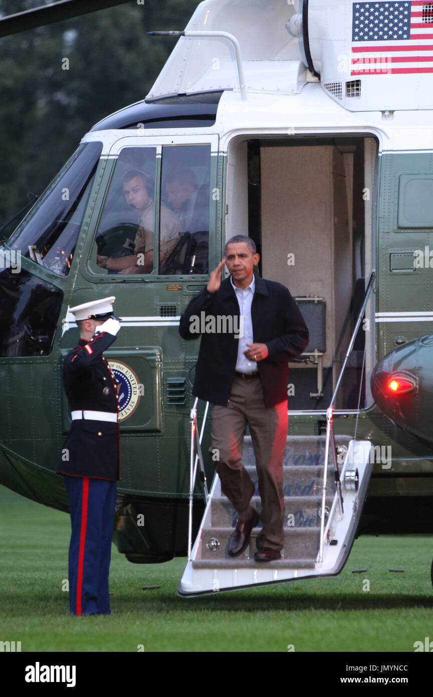 United States President Barack Obama salutes the Marine Guard as he ...