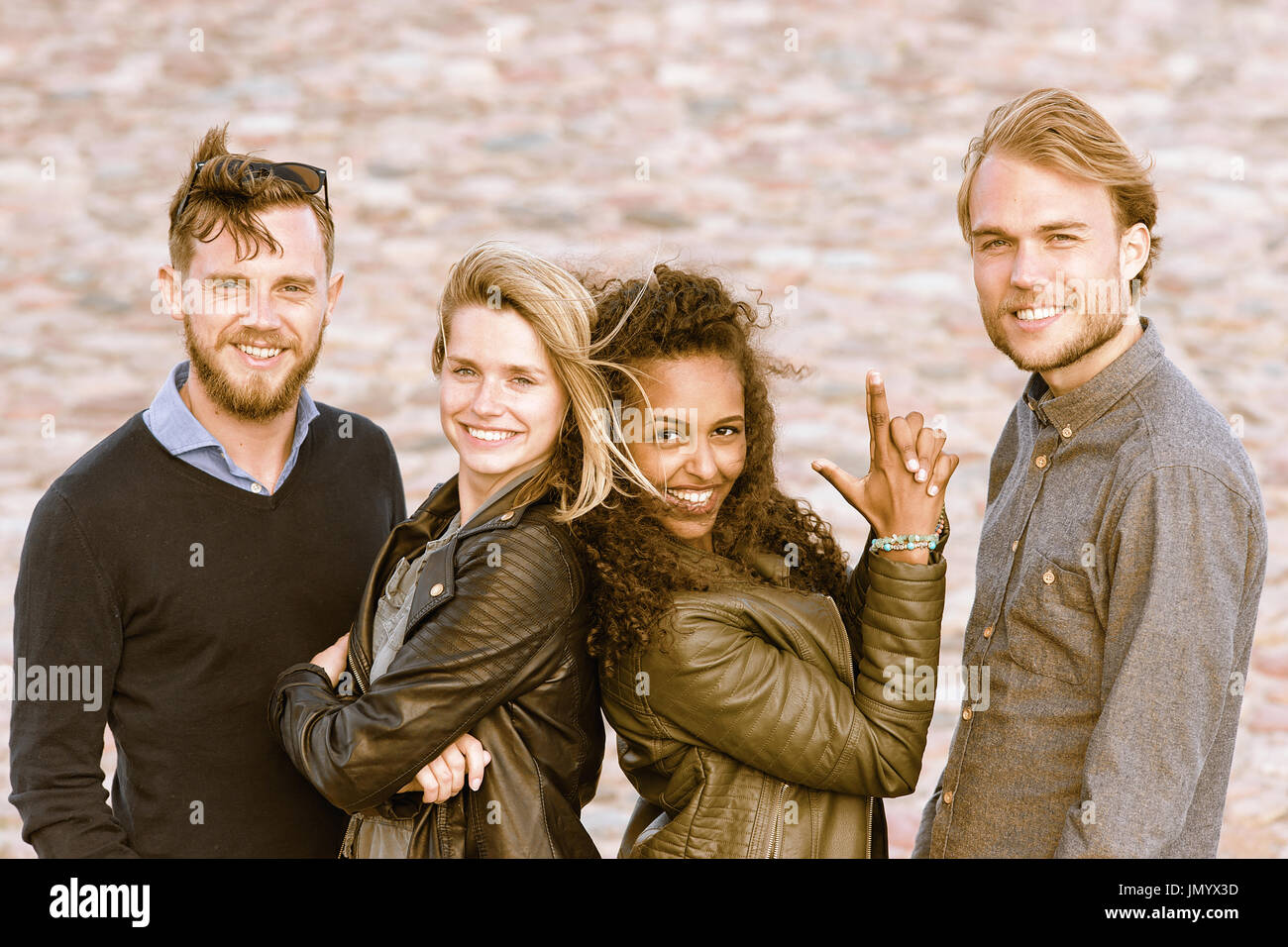Smiling young mixed race girl with her caucasian friends as diversity ...