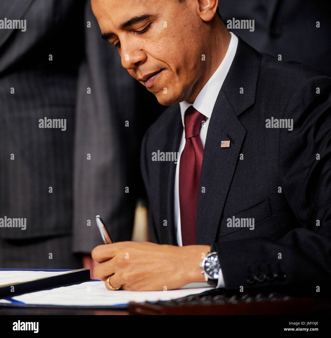 United States President Barack Obama signs the middle-class tax cut ...