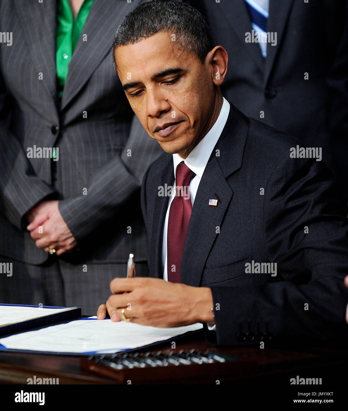 United States President Barack Obama signs the middle-class tax cut ...