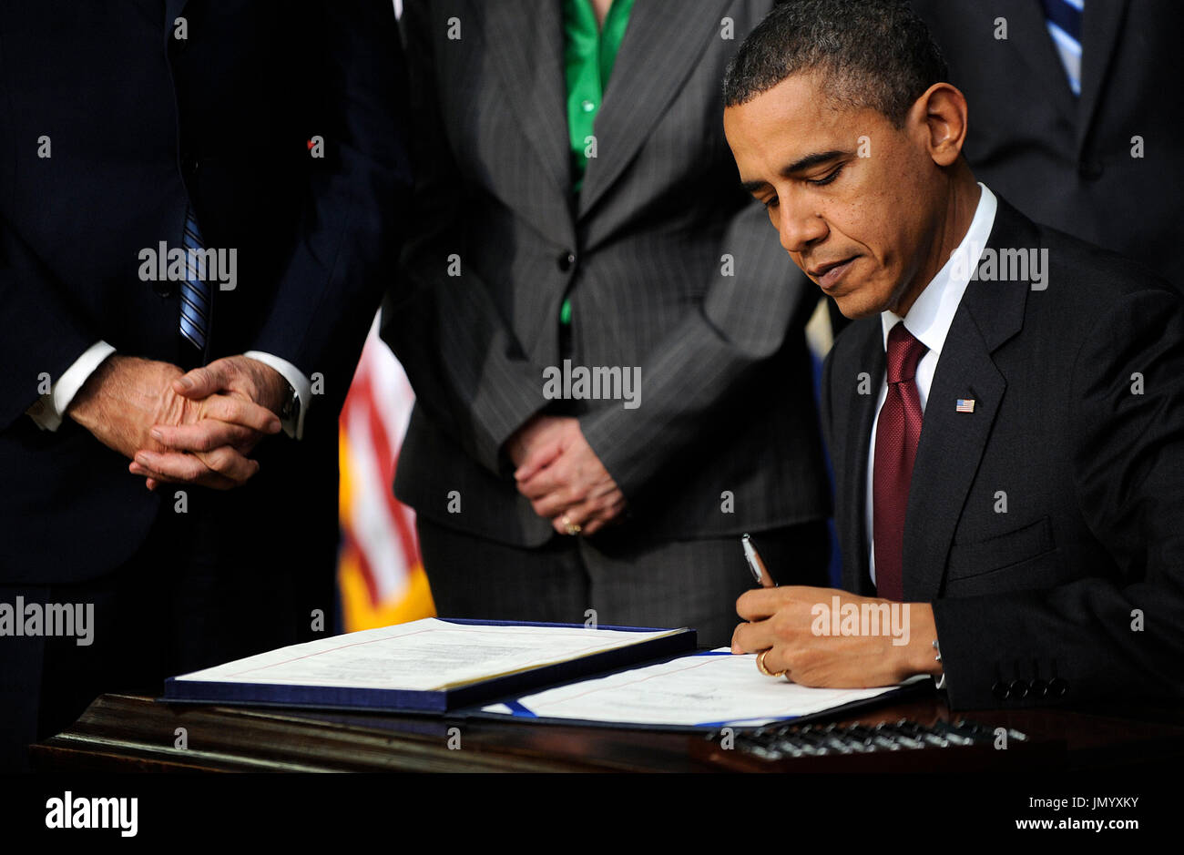 United States President Barack Obama signs the middle-class tax cut ...