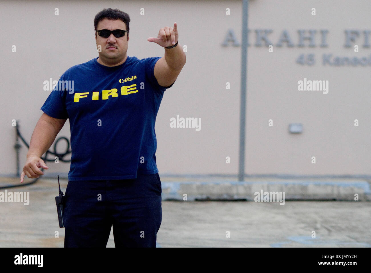 A Honolulu Fire Department firefighter waves a 'shaka,' a gesture of ...