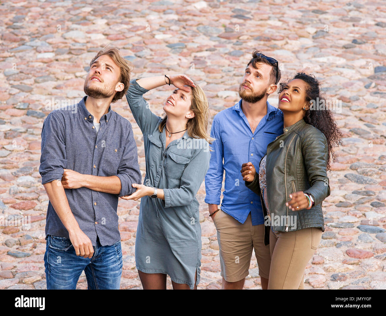 Young friends looking up with interest Concept Stock Photo - Alamy