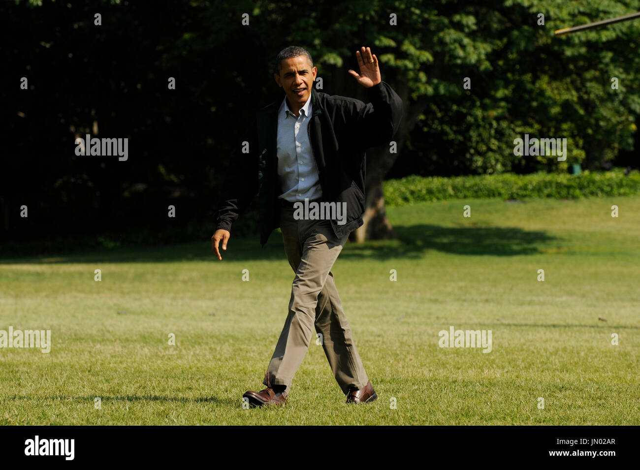 United States President Barack Obama waves while walking across the ...