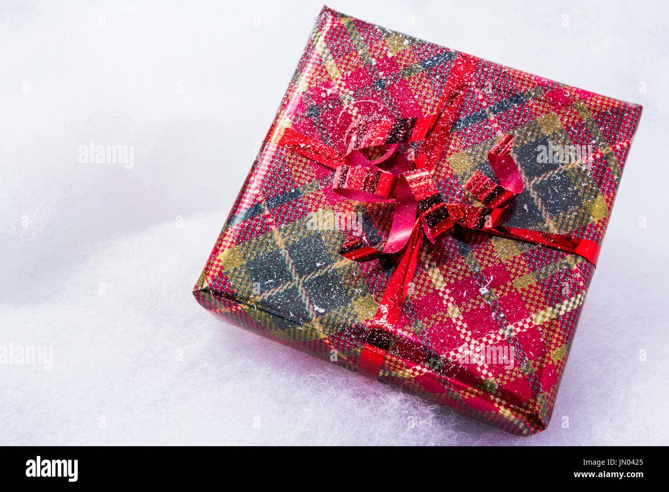 Single Christmas Gift wrapped in Red and Gold patterned glossy paper ...