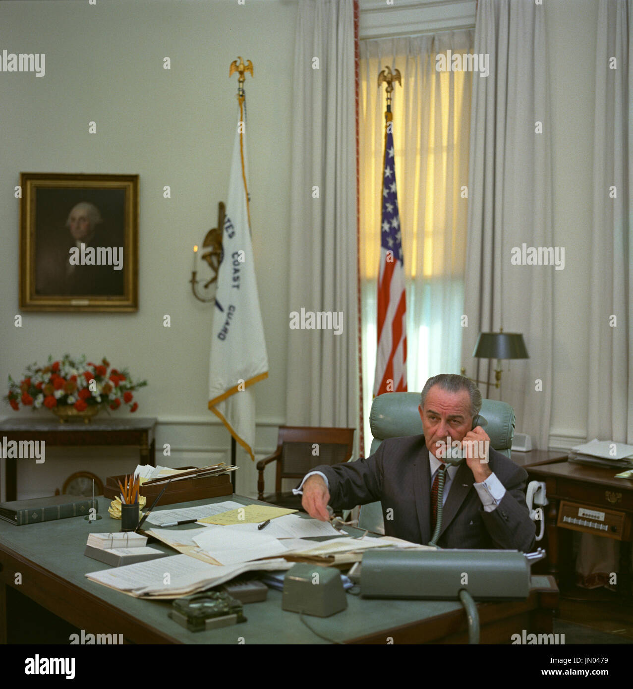 United States President Lyndon B. Johnson sits at his desk in the Oval ...
