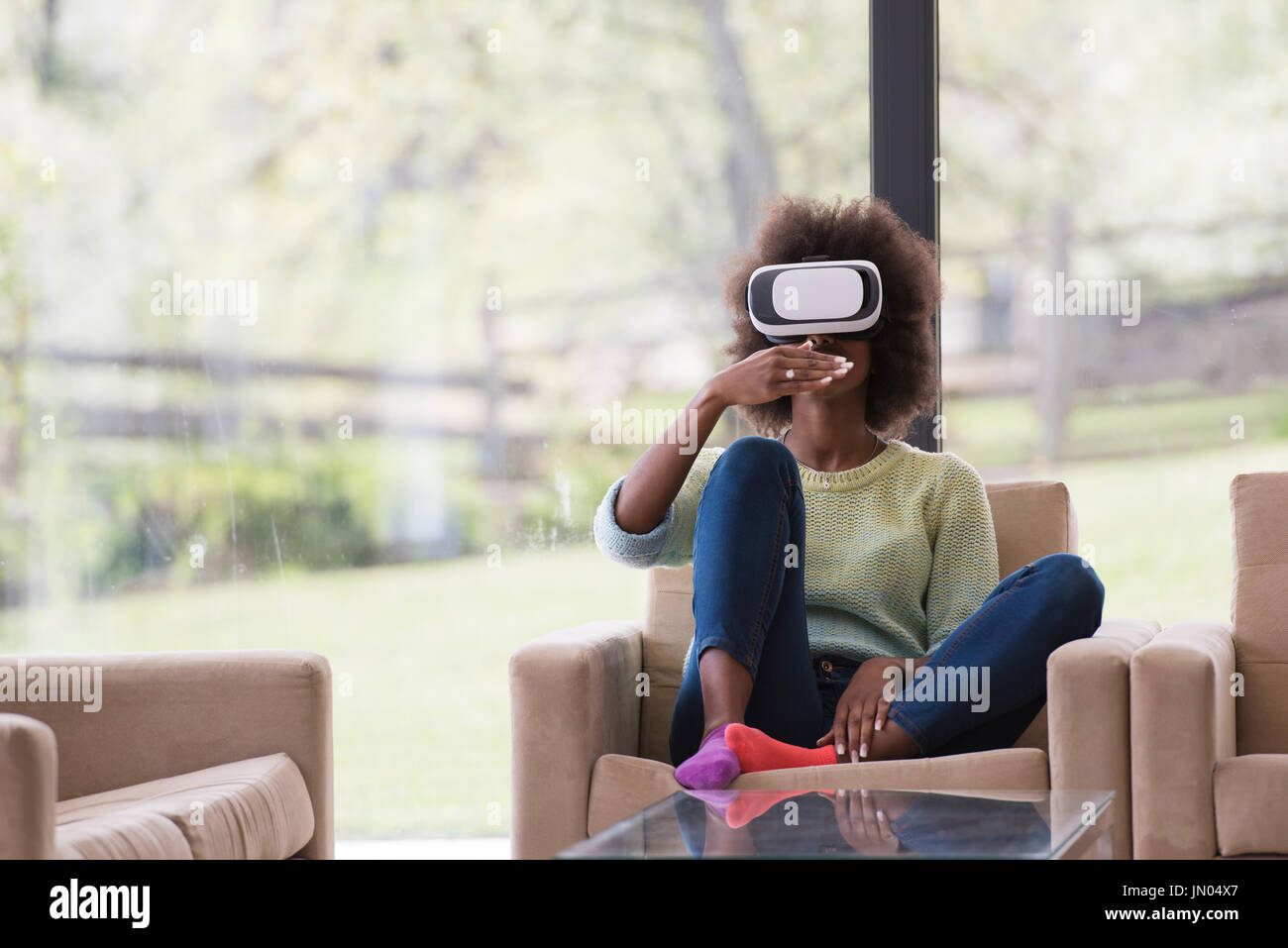 Happy african american girl getting experience using VR headset glasses ...