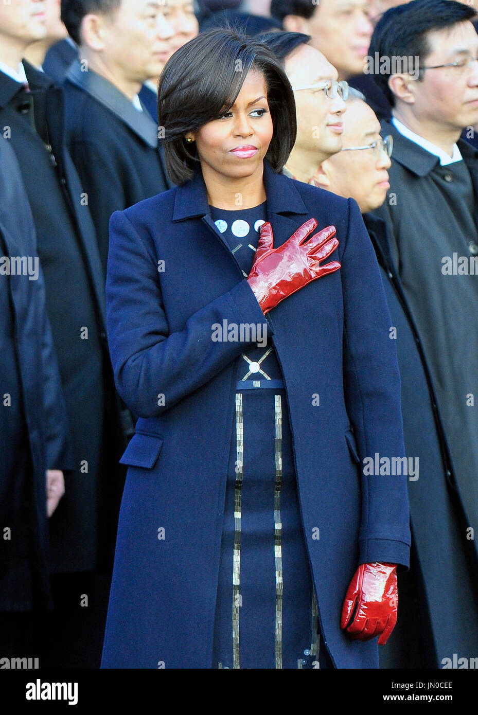 First lady Michelle Obama holds her hand over her heart as the National ...