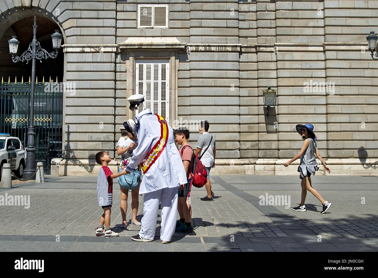 Mother gives a tip to a street performer after children were playing ...