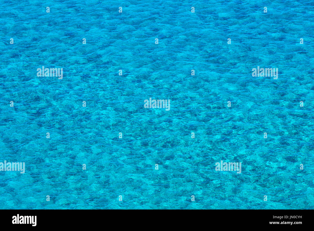 Blue sea flowing water surface with waves and sun glitters. Abstract ...