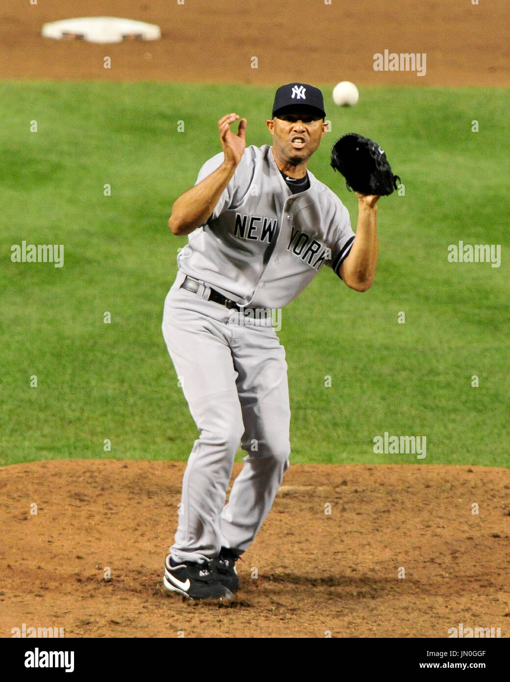 New York Yankees pitcher Mariano Rivera (42) tries to field a a ball ...