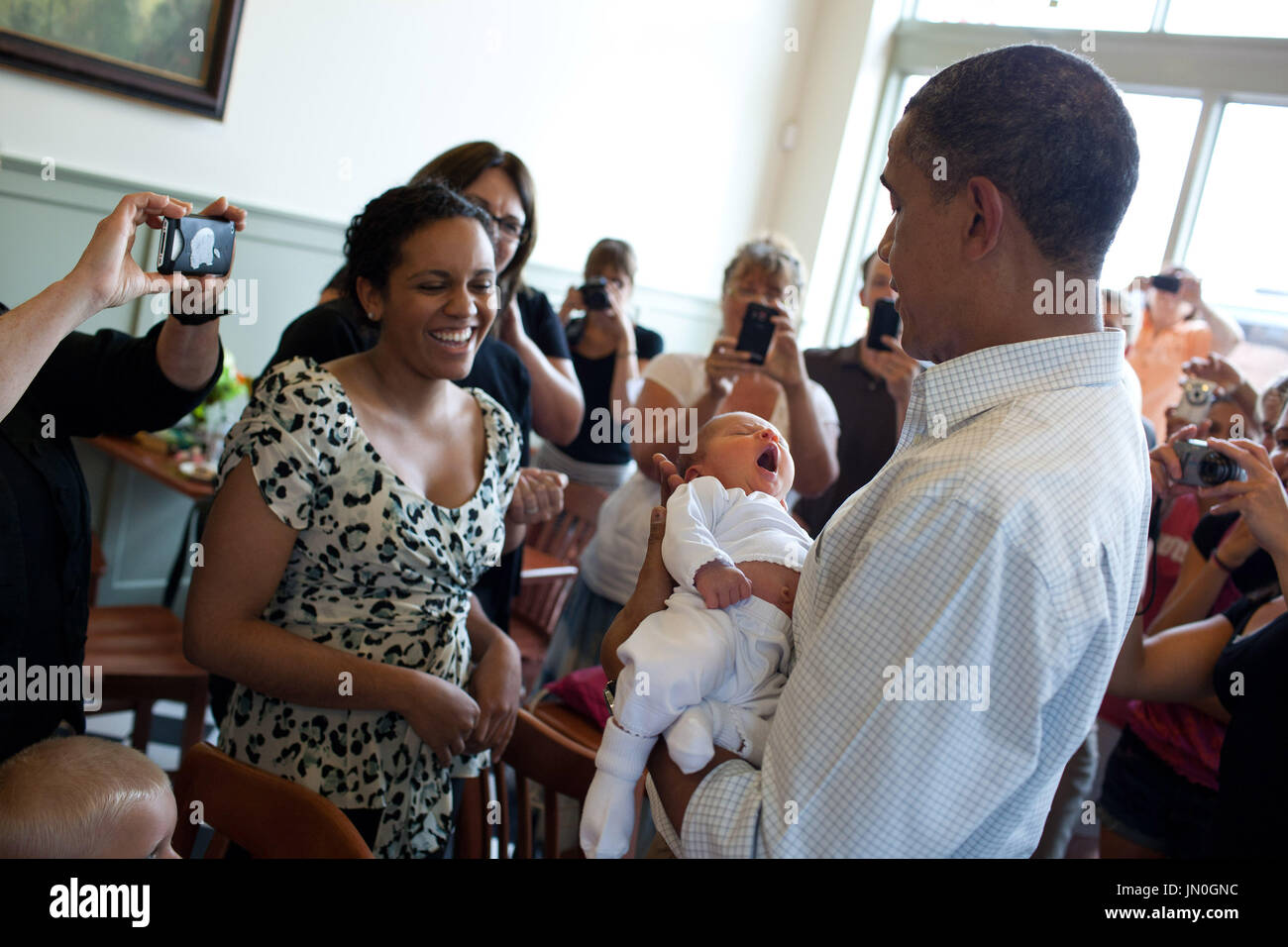 United States President Barack Obama holds a baby as he arrives for ...