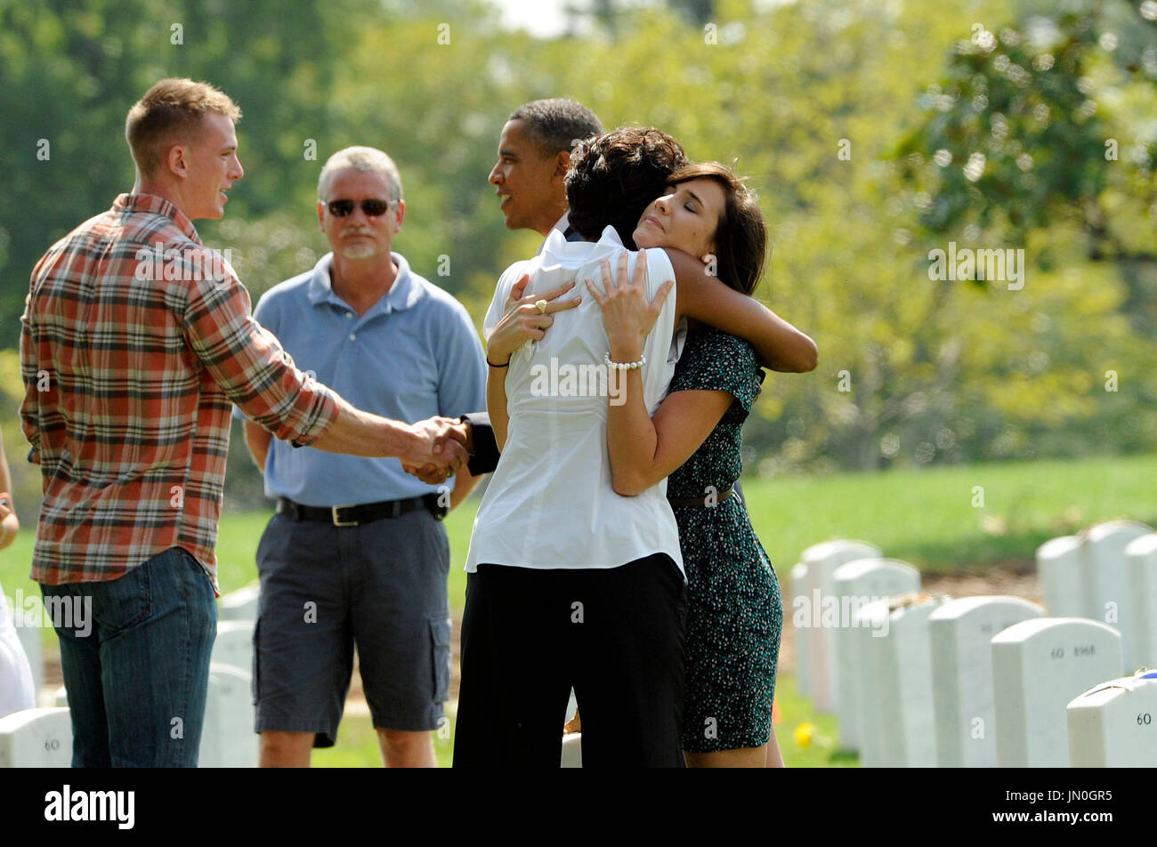 First Lady Michelle Obama hugs an unidentified woman as she and United ...