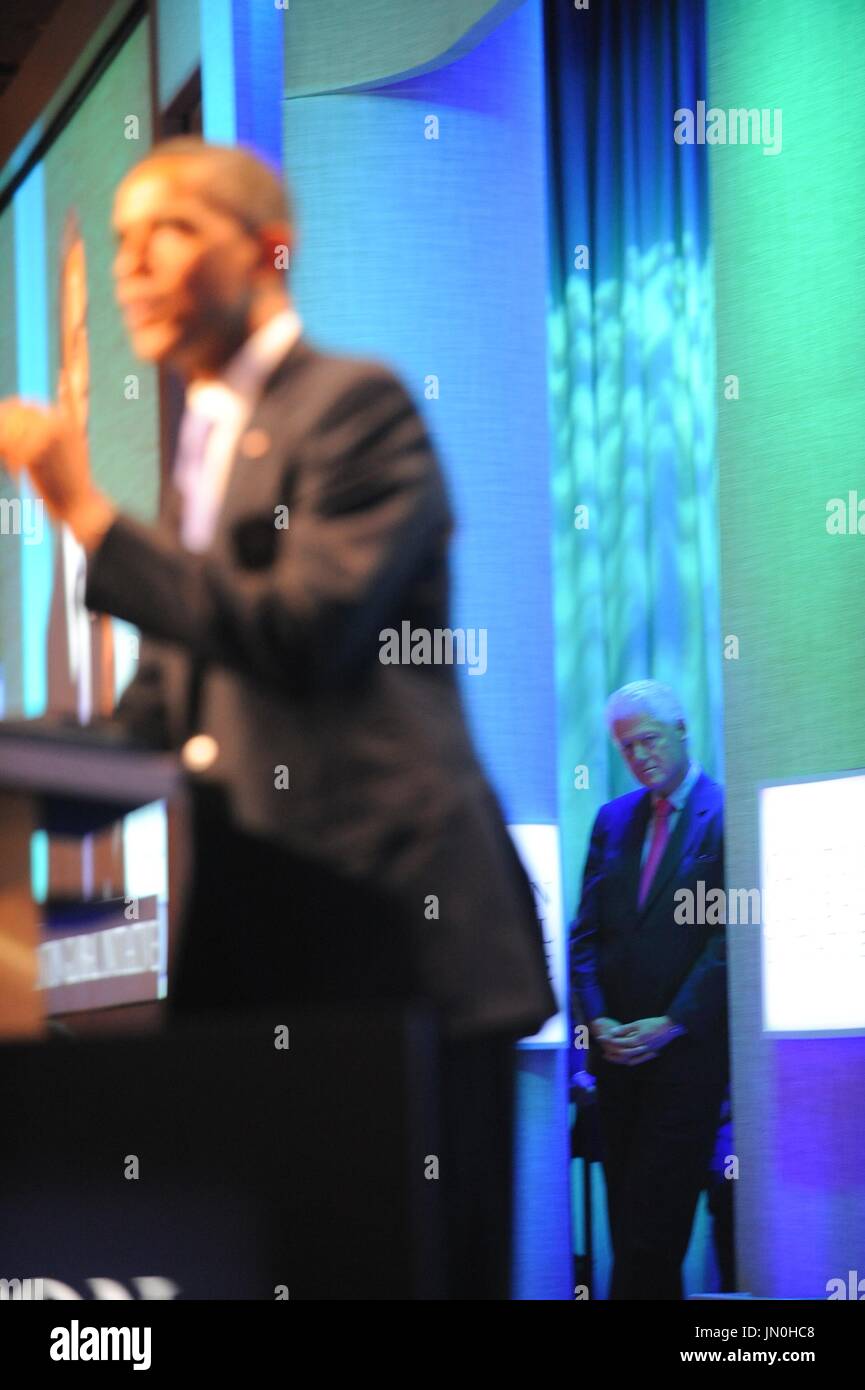 Former United States President Bill Clinton, right, listens after ...