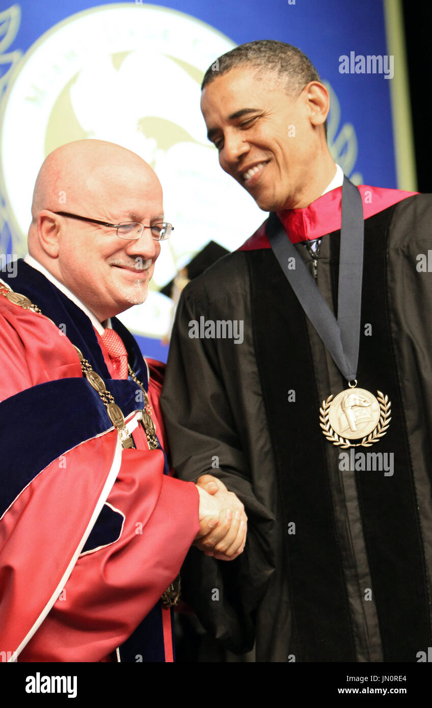 United States President Barack Obama (R) shakes hands with Dr. Jose A ...