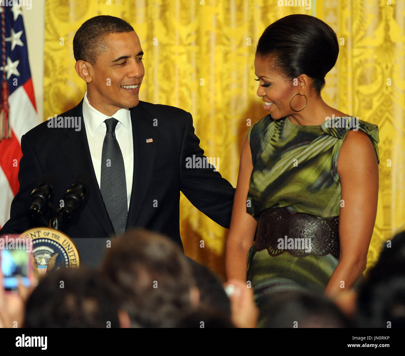 United States President Barack Obama puts his arm around First Lady ...