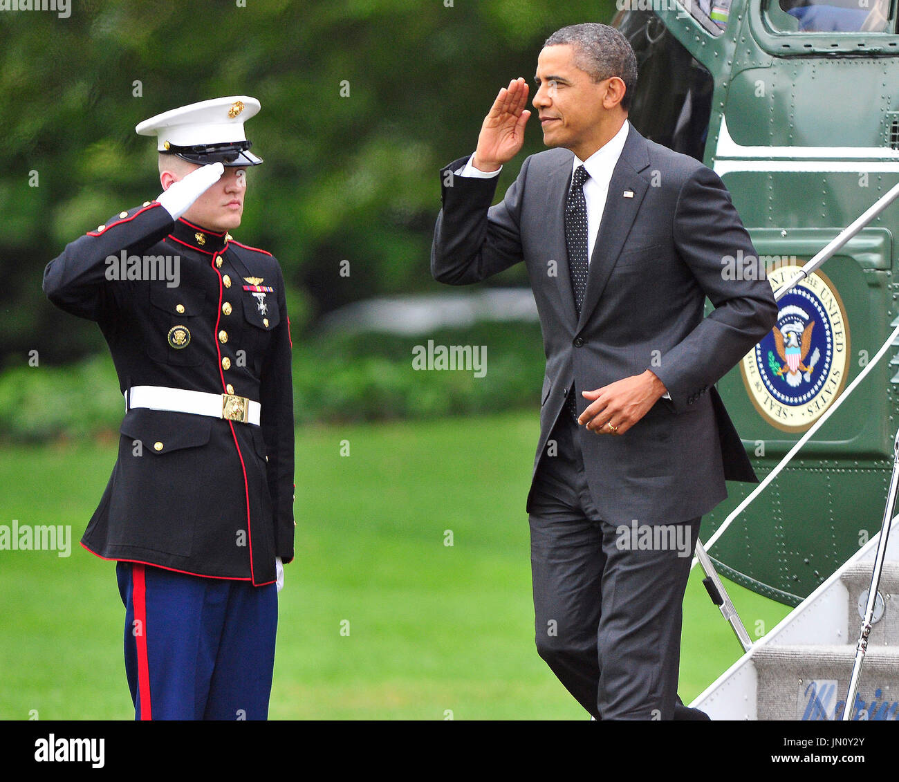 United States President Barack Obama salutes the Marine Guard after ...