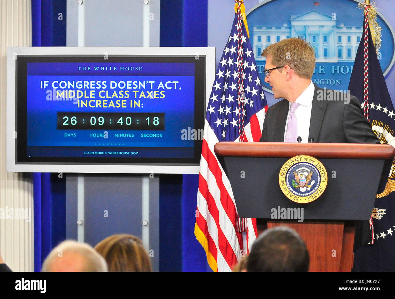 White House Press Secretary Jay Carney looks at the new count-down ...
