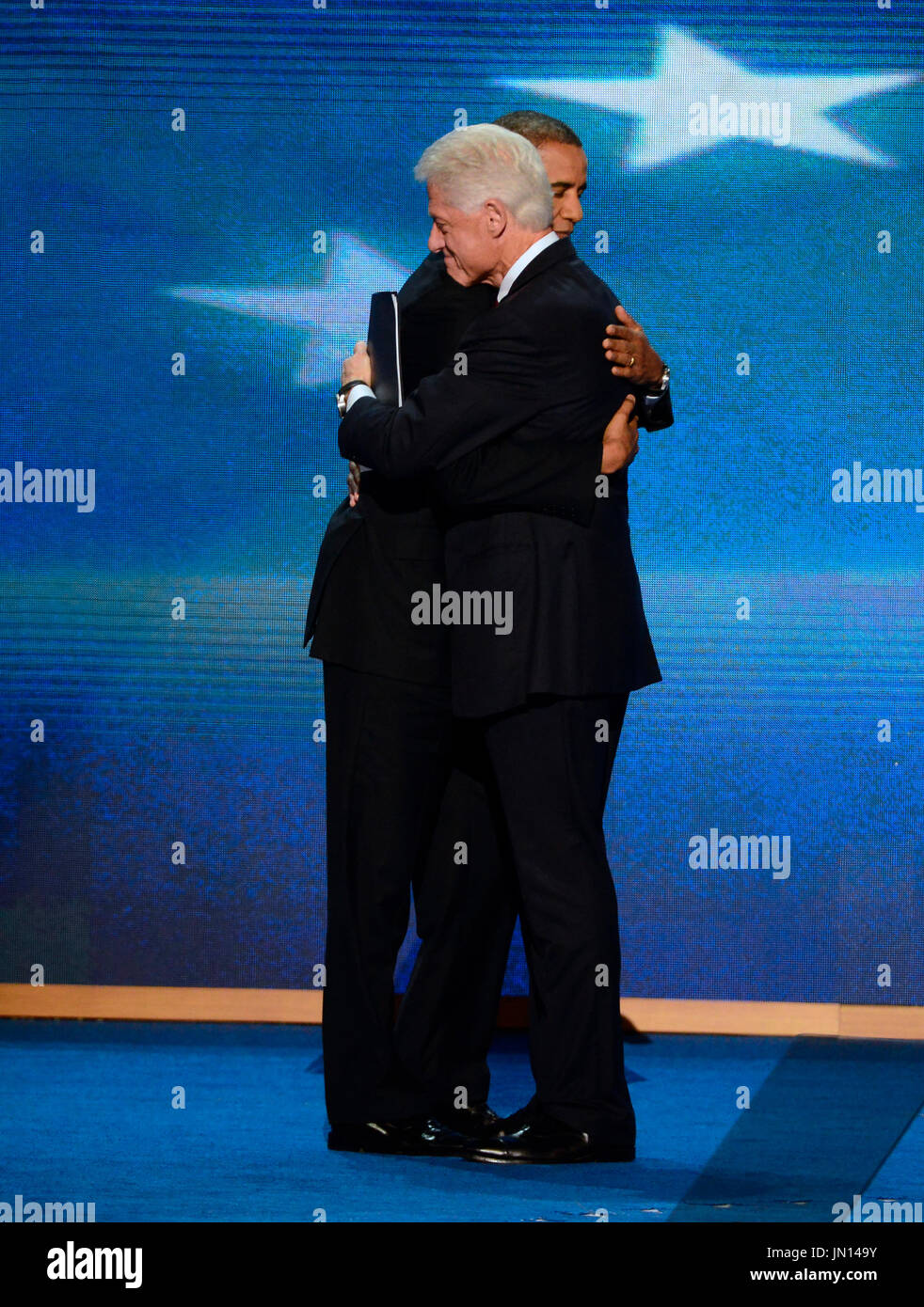 Former United States President Bill Clinton hugs U.S. President Barack ...