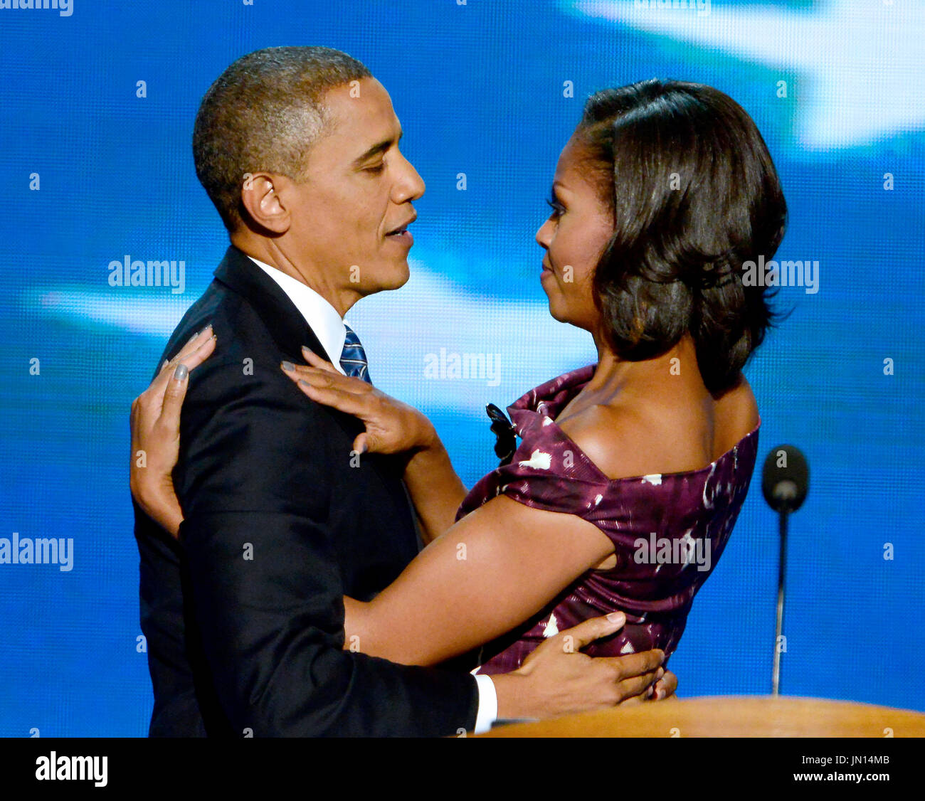 First lady Michelle Obama wipes the suit of her husband, United States ...