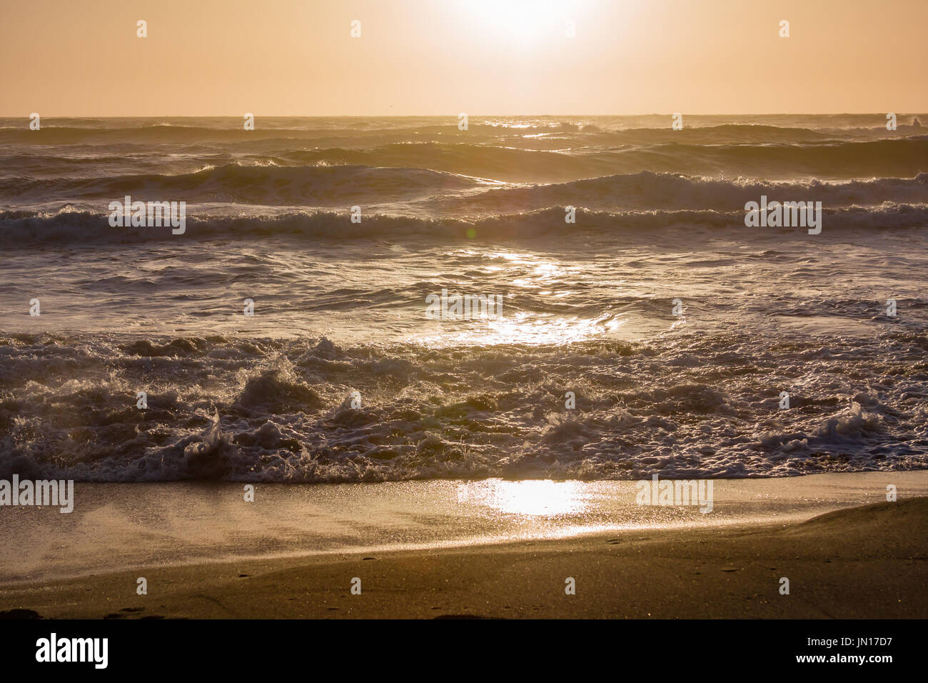 sunset beach water waves Stock Photo - Alamy