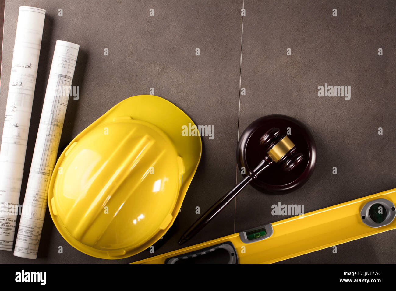 Construction law. Helmet and gavel. Stone table Stock Photo - Alamy