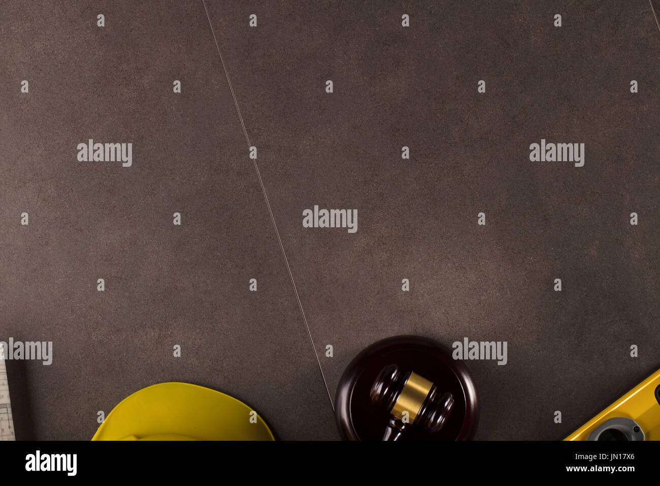 Construction law. Helmet and gavel. Stone table Stock Photo - Alamy