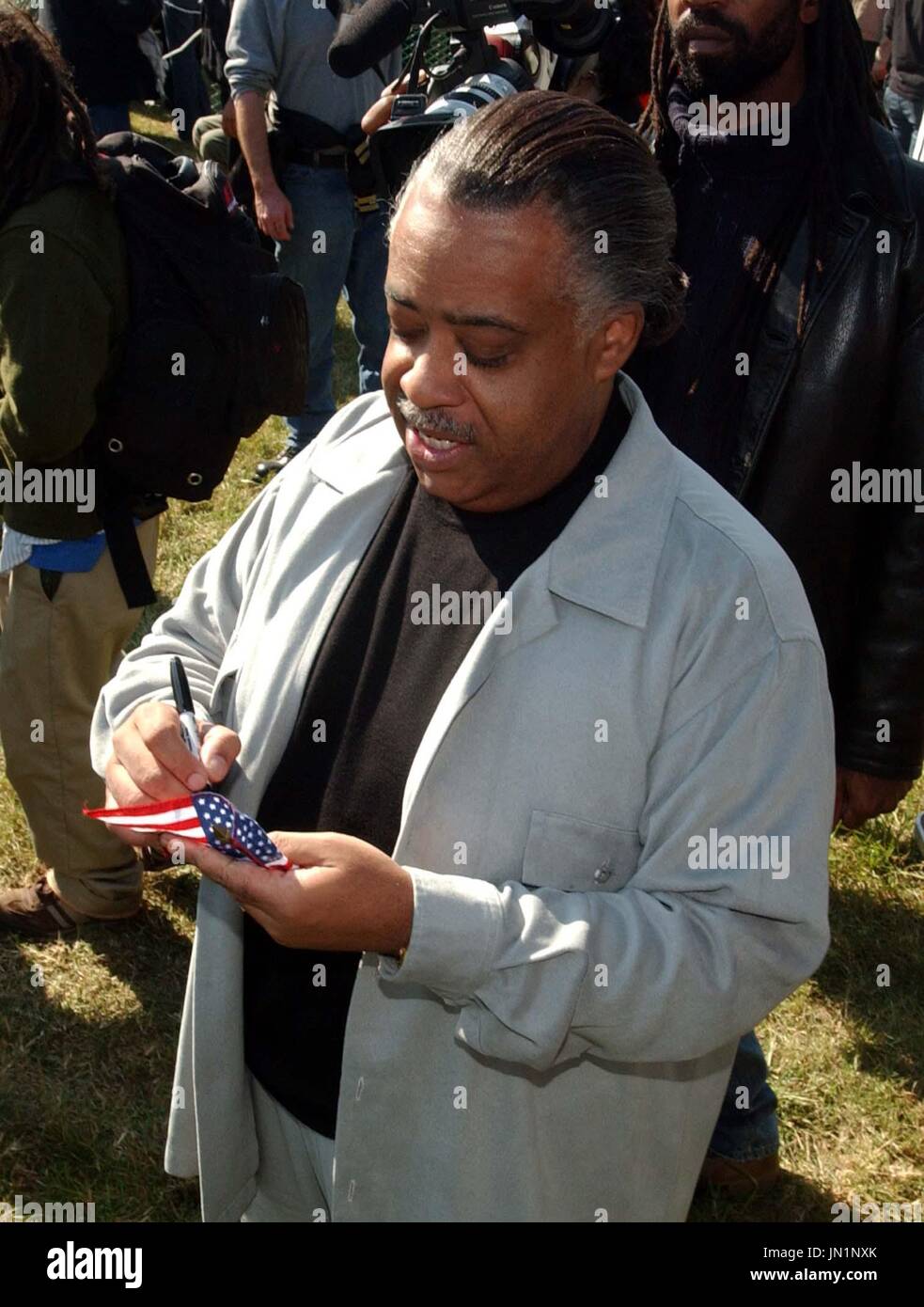 Reverend Al Sharpton signs an American flag for a well wisher after he ...