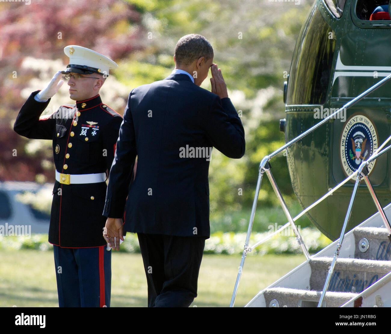 United States President Barack Obama salutes the Marine Guard as he ...