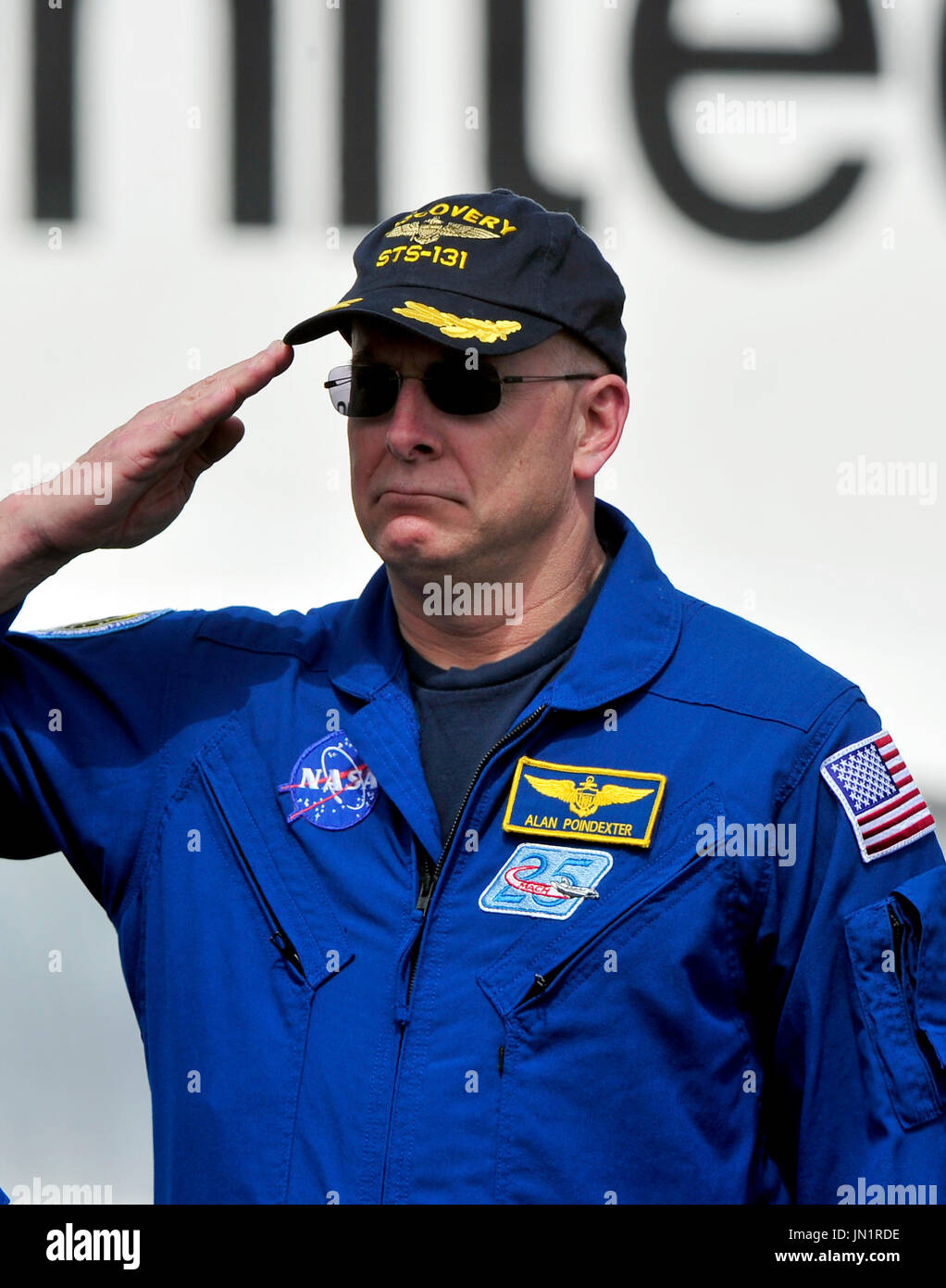 Alan Poindexter, Commander of the STS-131 mission, salutes as the ...