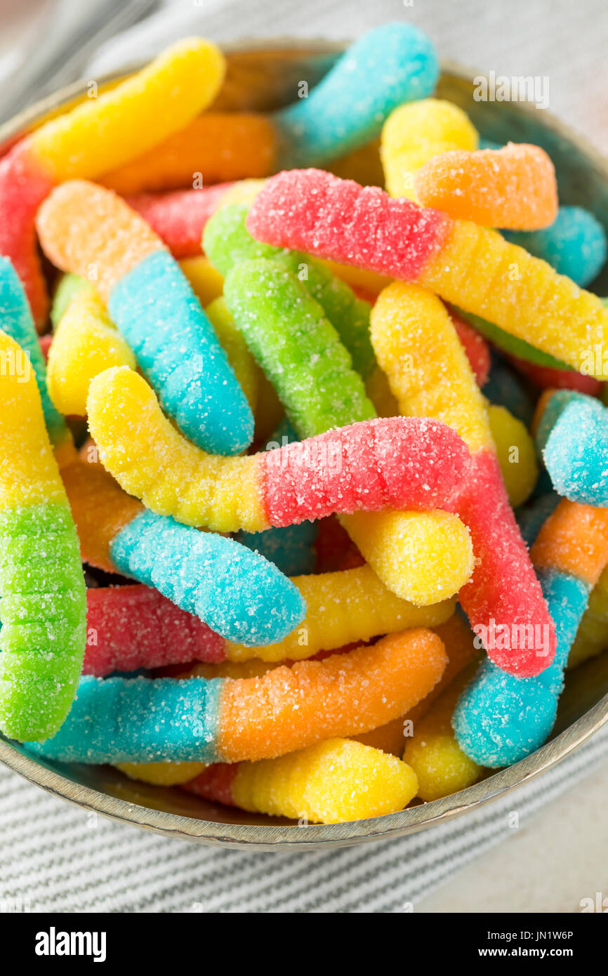 Sweet Sour Neon Gummy Worms with a Sugar Coating Stock Photo - Alamy