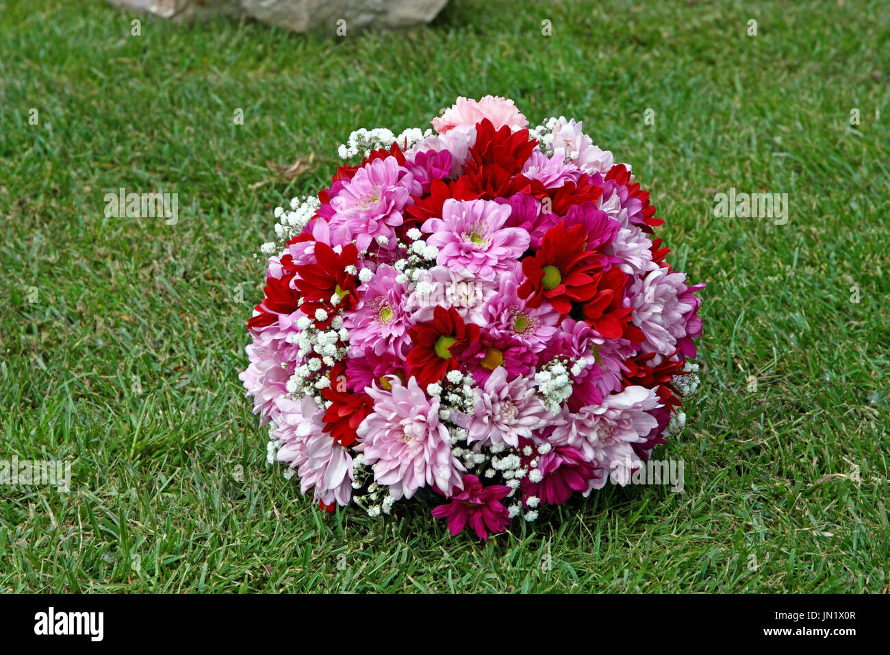 A ball of flowers on green background Stock Photo - Alamy
