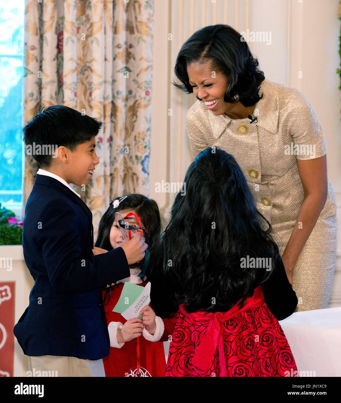 First lady Michelle Obama helps children with a crafts project during ...