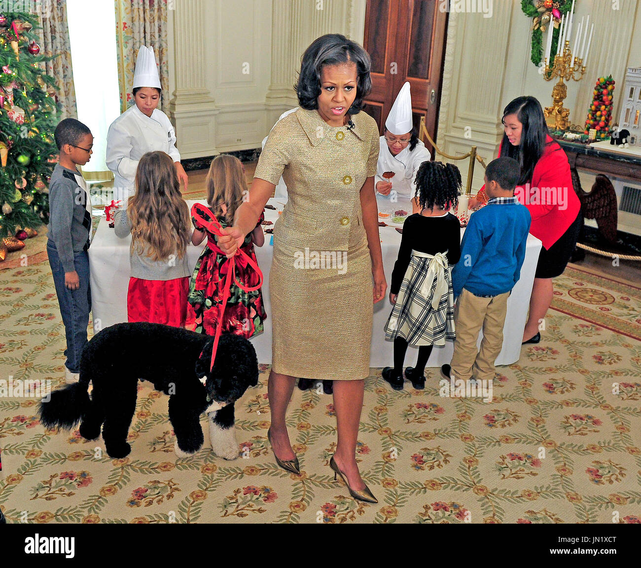 First lady Michelle Obama walks Bo through the State Dining Room during ...