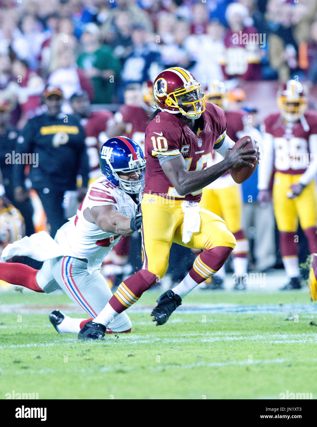 Washington Redskins quarterback Robert Griffin III (10) scrambles away ...