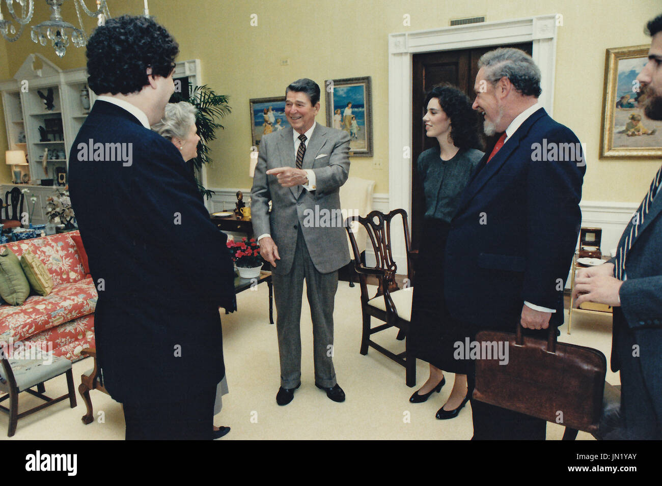 United States President Ronald Reagan, center, joins Judge Robert H ...