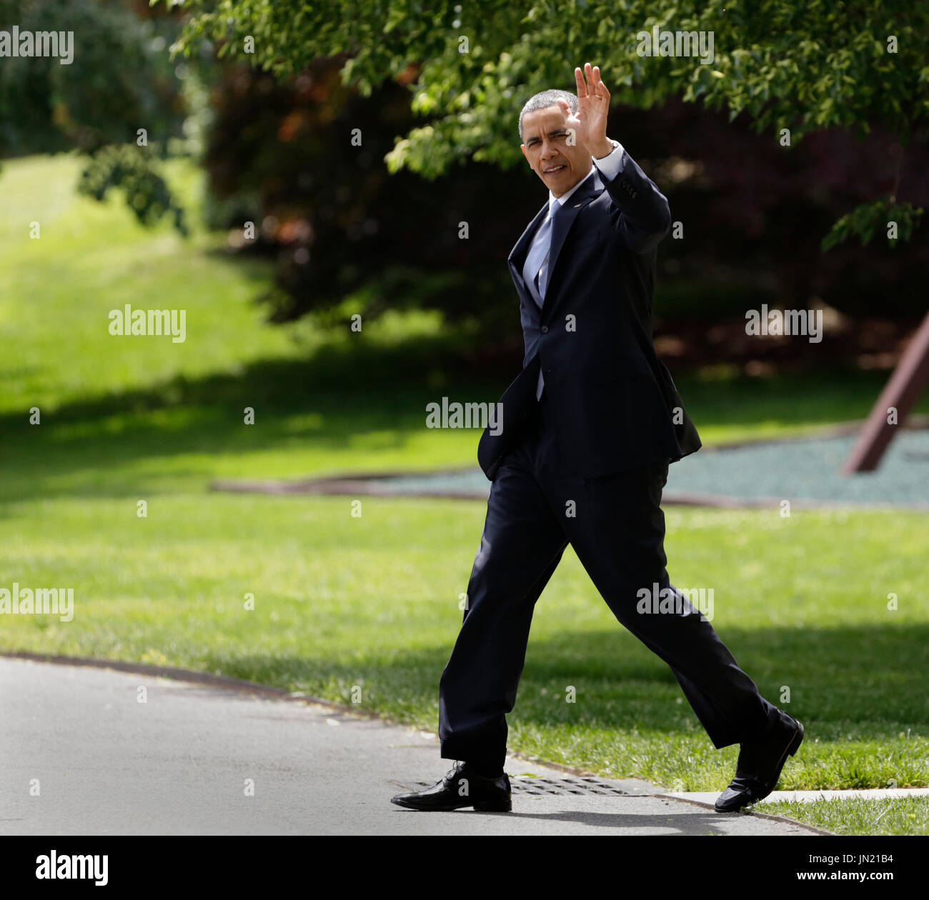 United States President Barack Obama waves as he departs the White ...