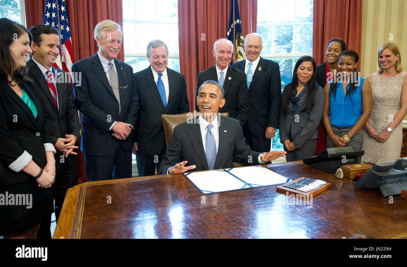 United States President Barack Obama smiles after signing the ...