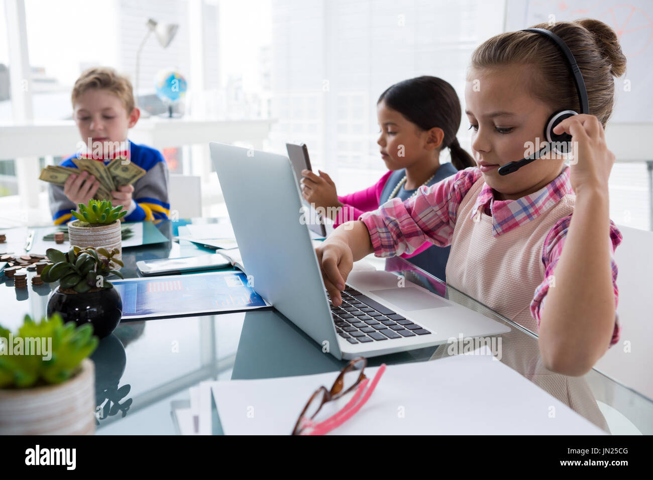 Kids as business executives working together in office Stock Photo - Alamy