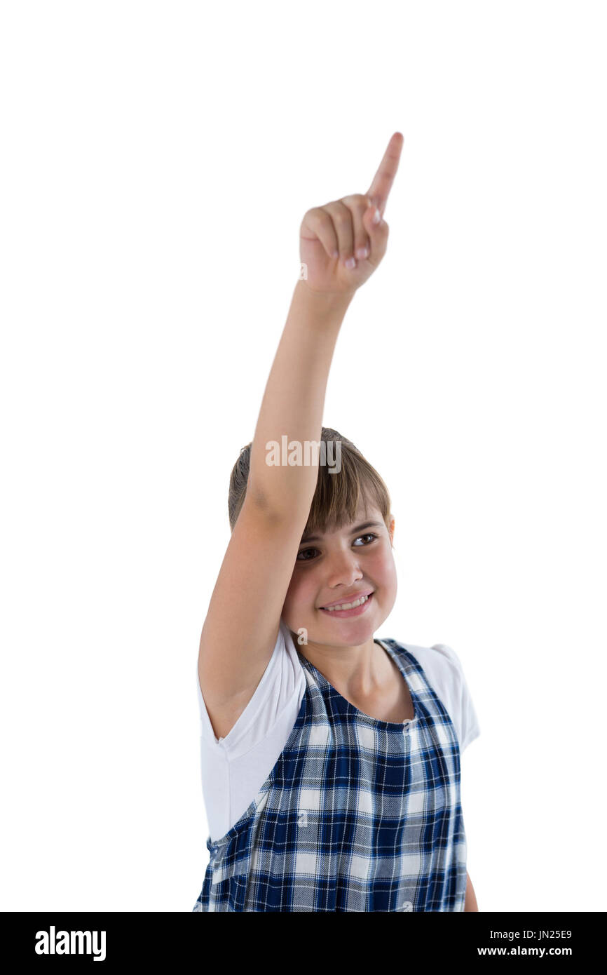 Cute girl raising hand against white background Stock Photo - Alamy