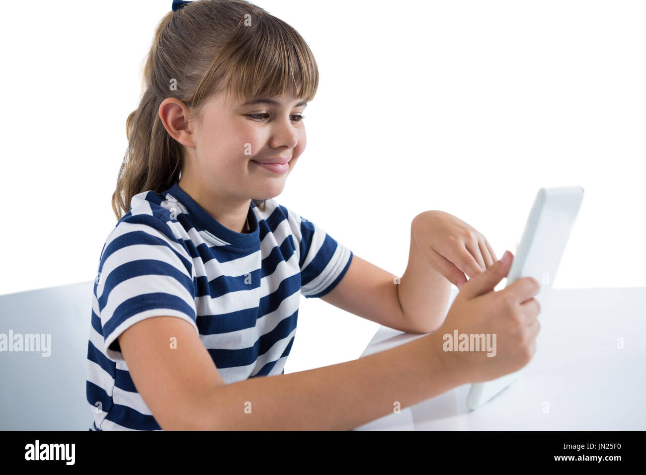 Cute girl using digital tablet at table against white background Stock ...